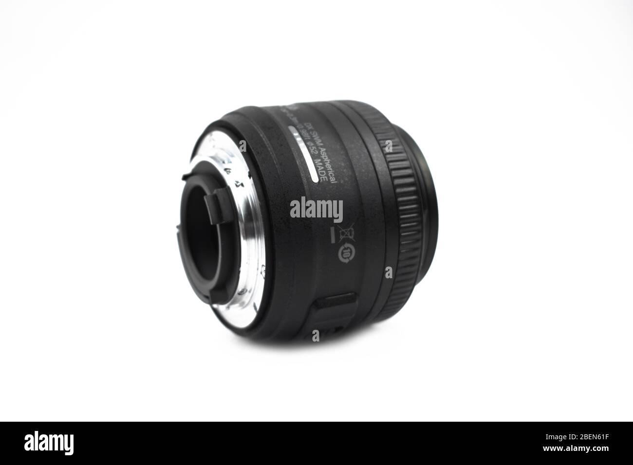 One black color camera lens of a digital camera placed over a white ...