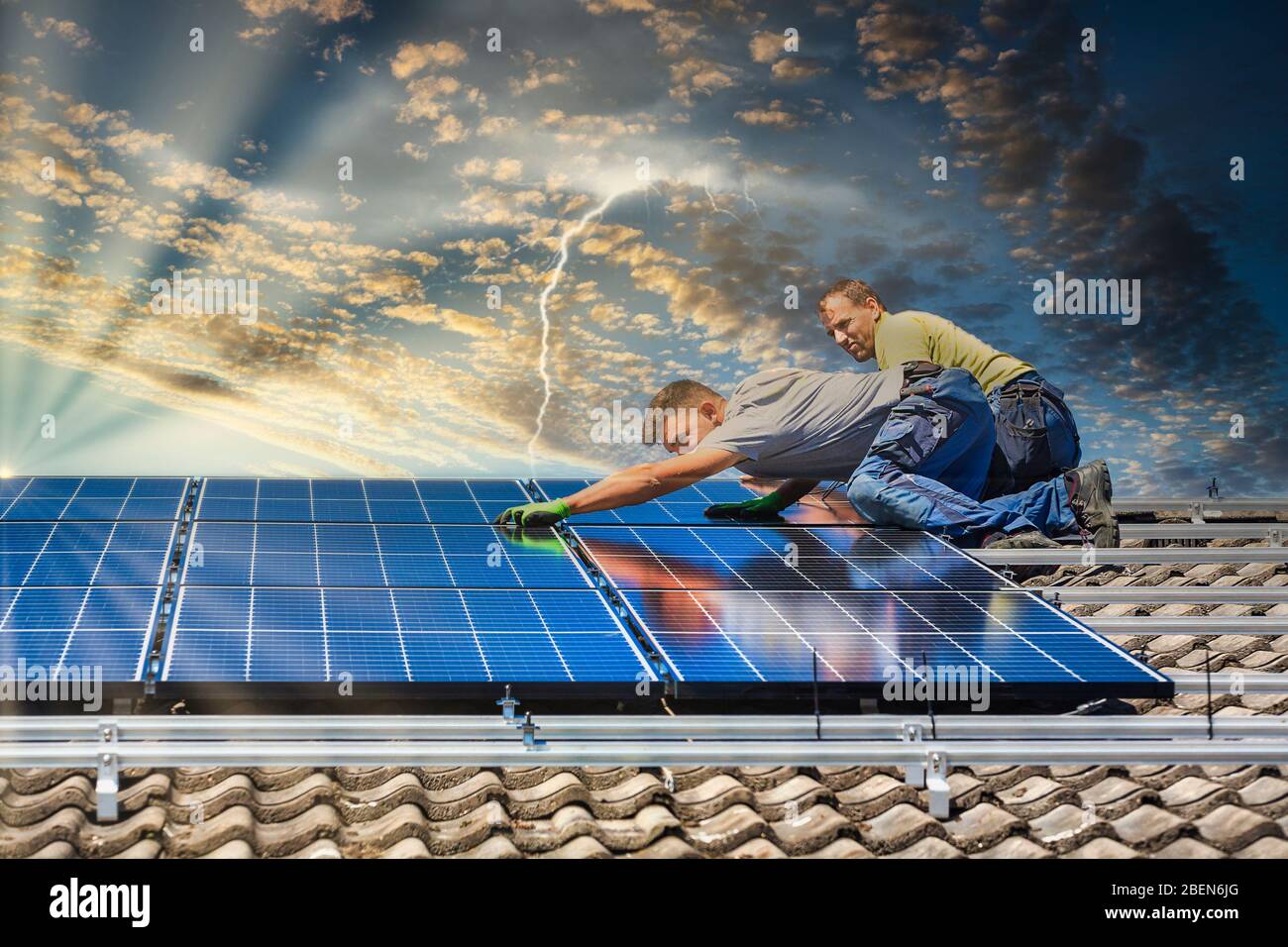 Portrait of workers installing photovoltaic panels on the roof Stock ...
