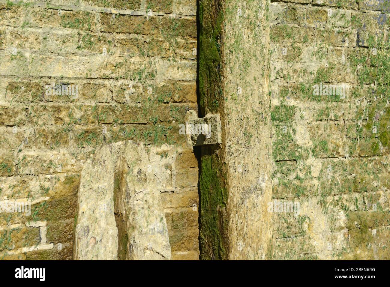 Detail of brick walling with wood stanchion at a small dock with ...