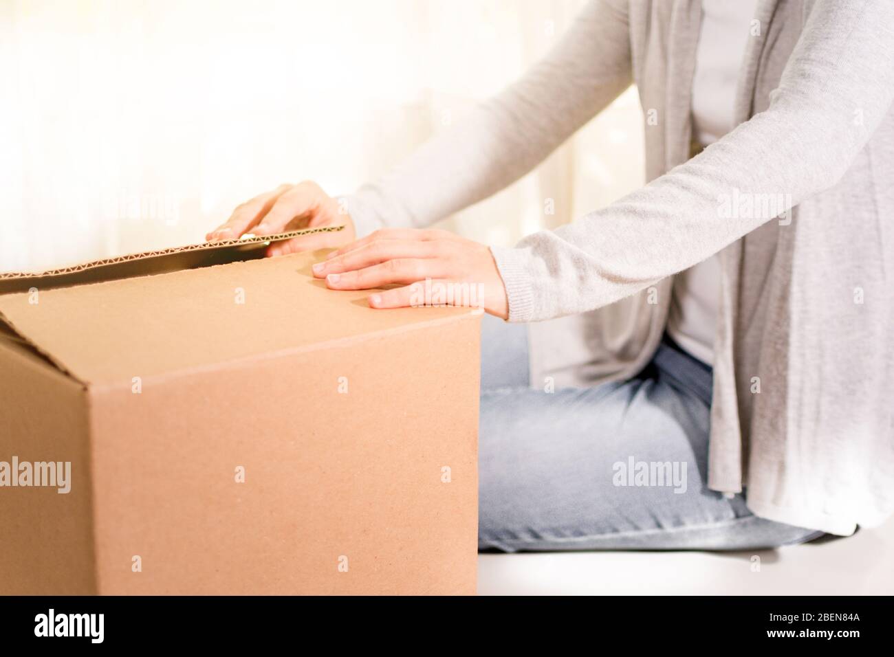 Stock photo of the hands of a woman opening a box. Photo with copy ...