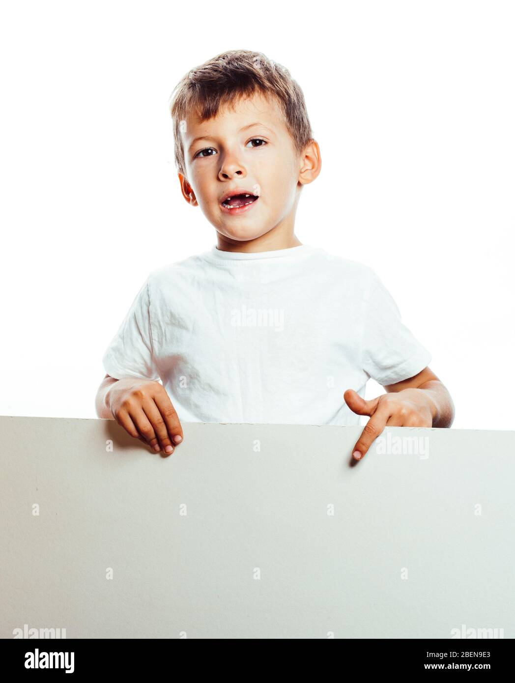 young pretty little boy wondering face gesturing, pointing isolated on ...