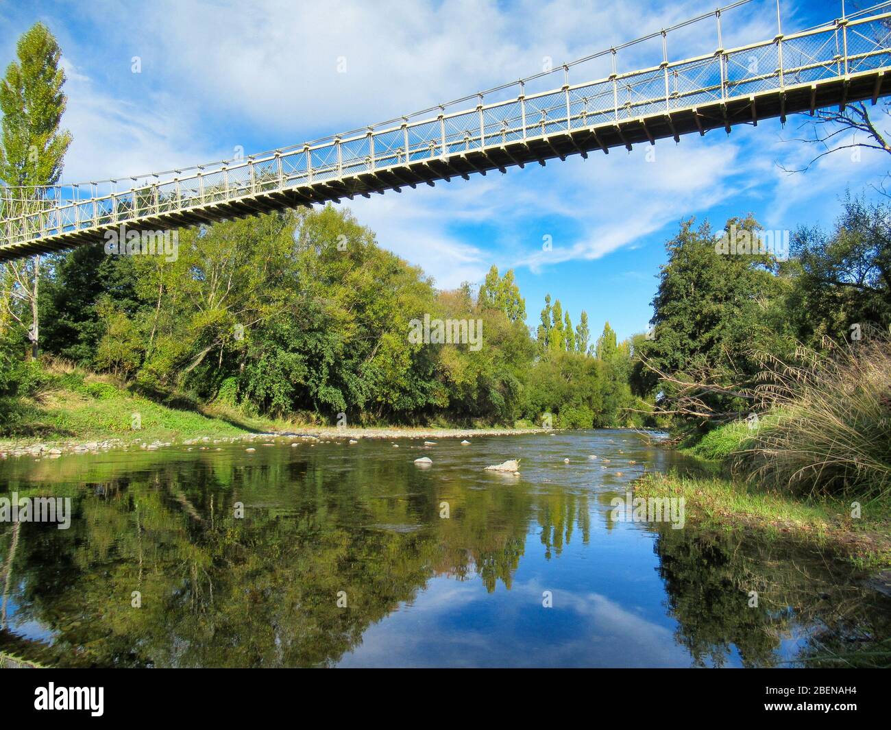 The peaceful river winding its way through trees and native vegetation ...