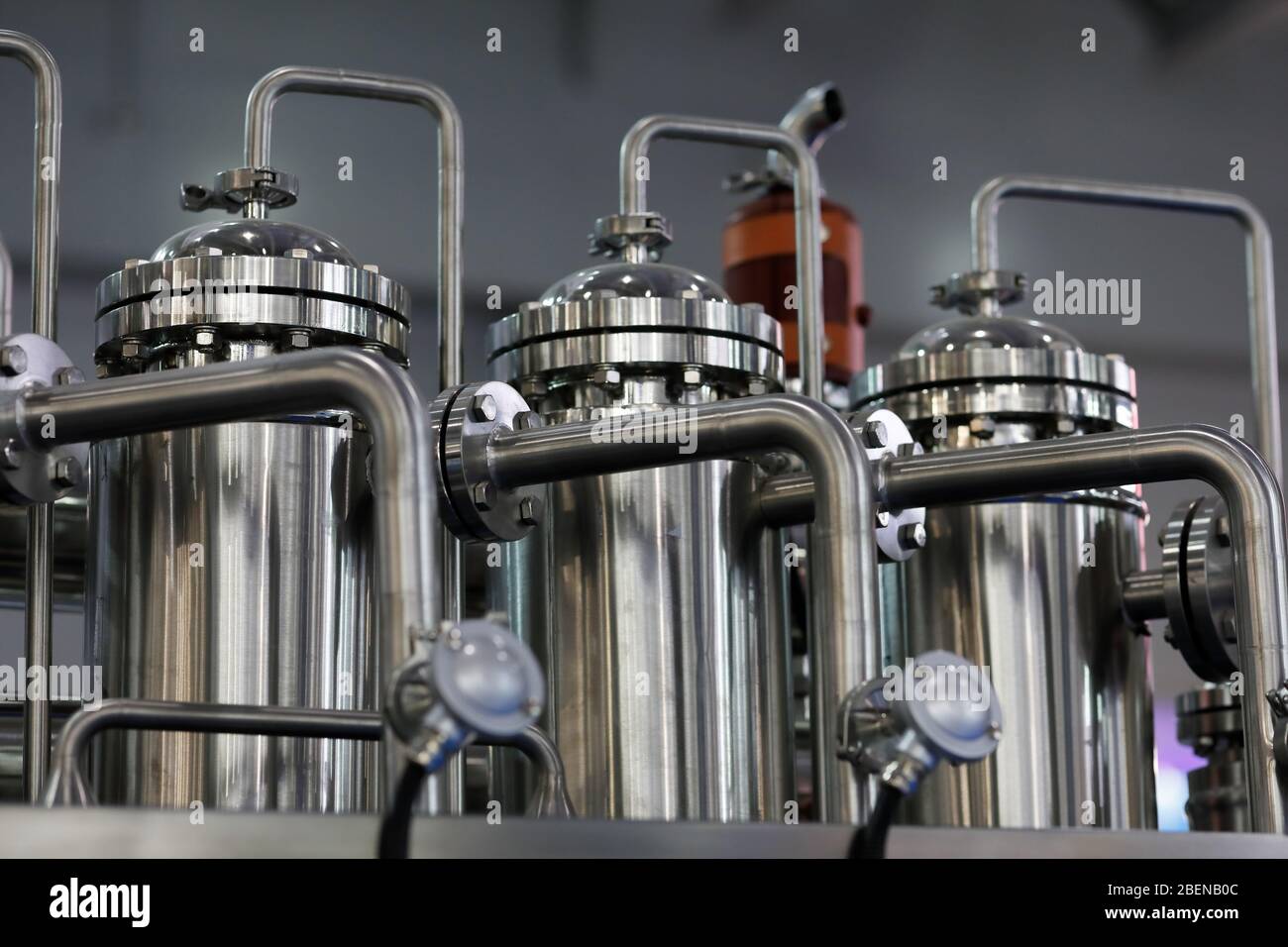Stainless steel tanks, pipes, and fittings. Closeup view of the system ...