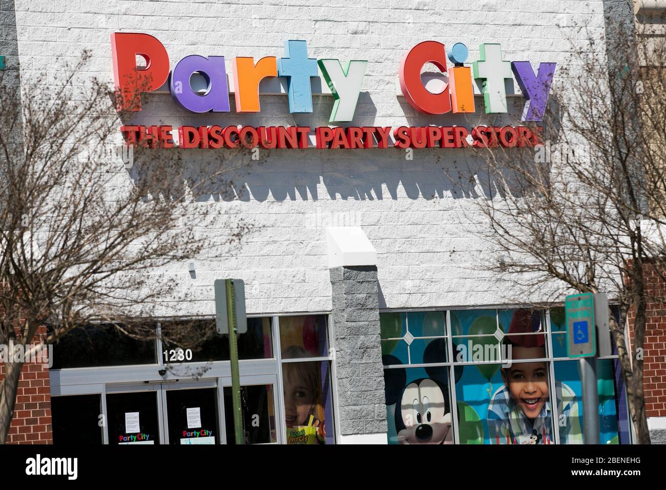 A logo sign outside of a Party City retail store location in ...