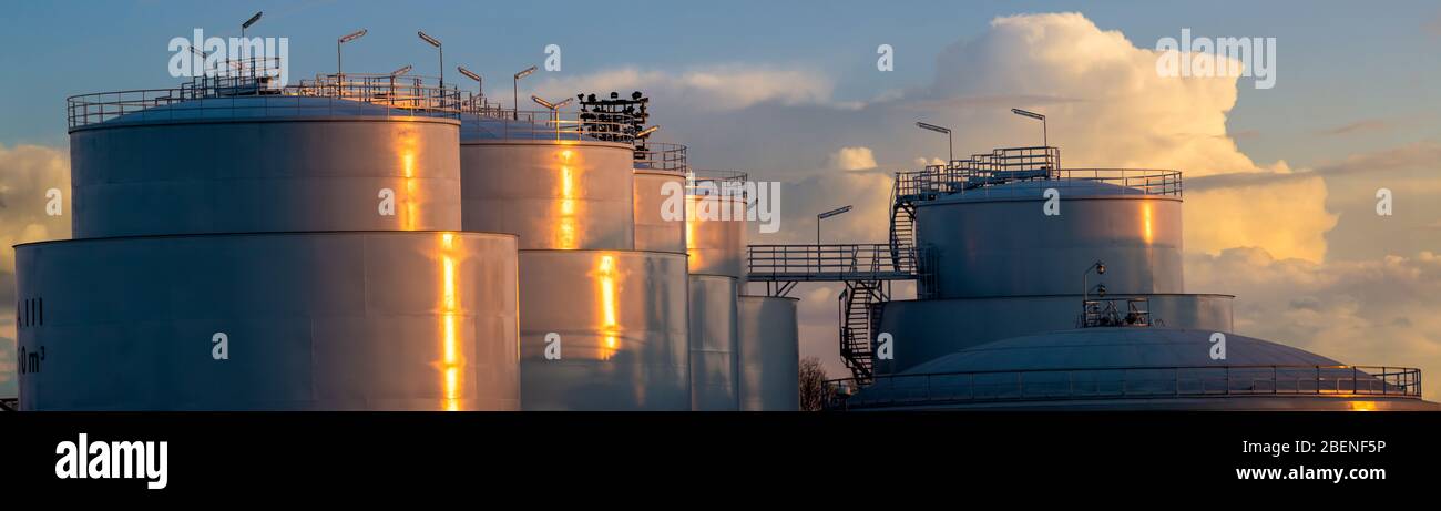 fuel tanks in the fuel warehouse in the light of the setting sun ...