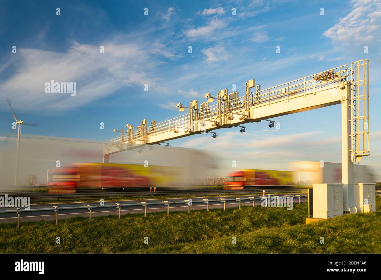 truck traffic under the highway gantry Stock Photo - Alamy