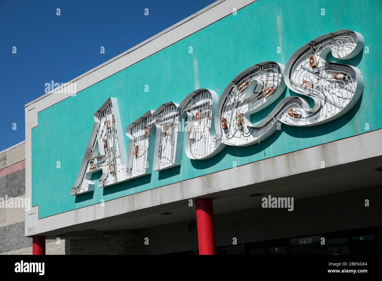 A logo sign outside of a closed and abandoned Ames Department Stores ...