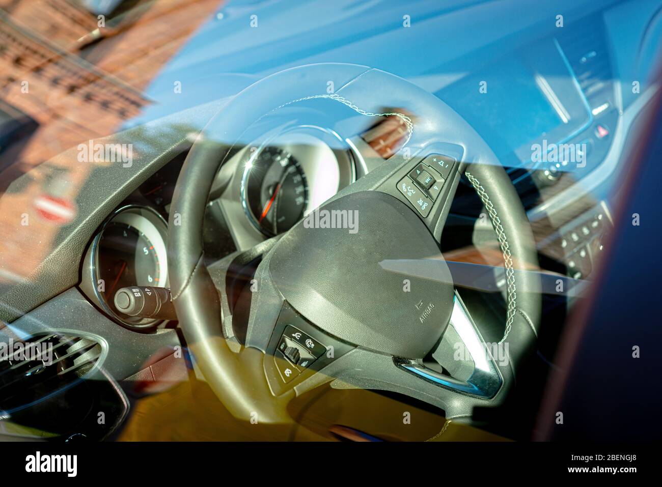 car dashboard and steering wheel through the window on a sunny day ...