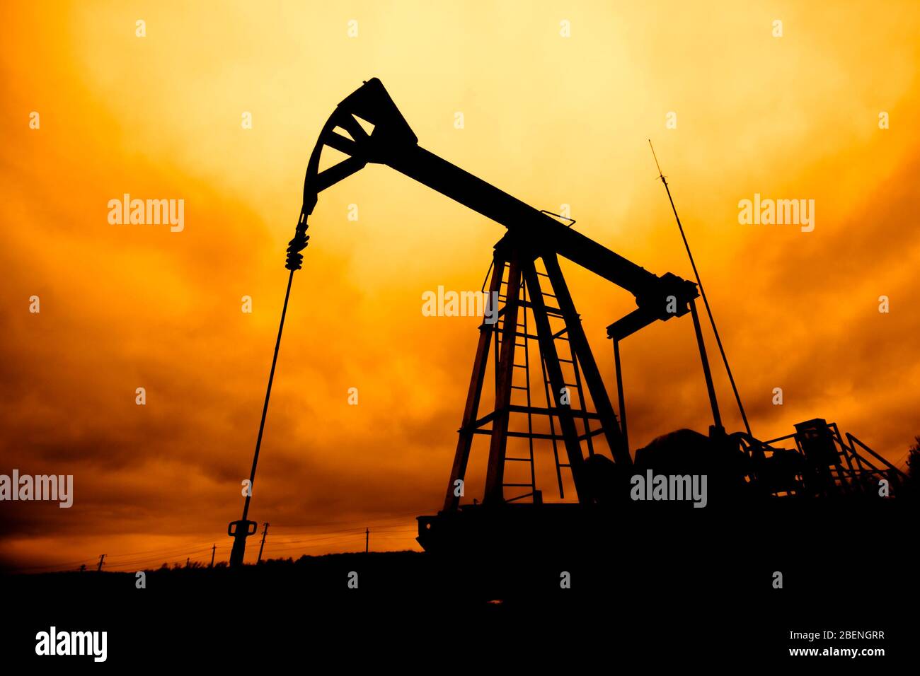Oil pump oil rig energy industrial machine for petroleum in the sunset ...