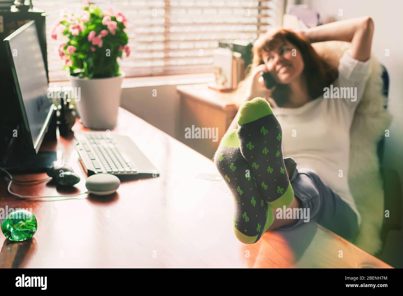 Work using internet feet on desk hi-res stock photography and images ...