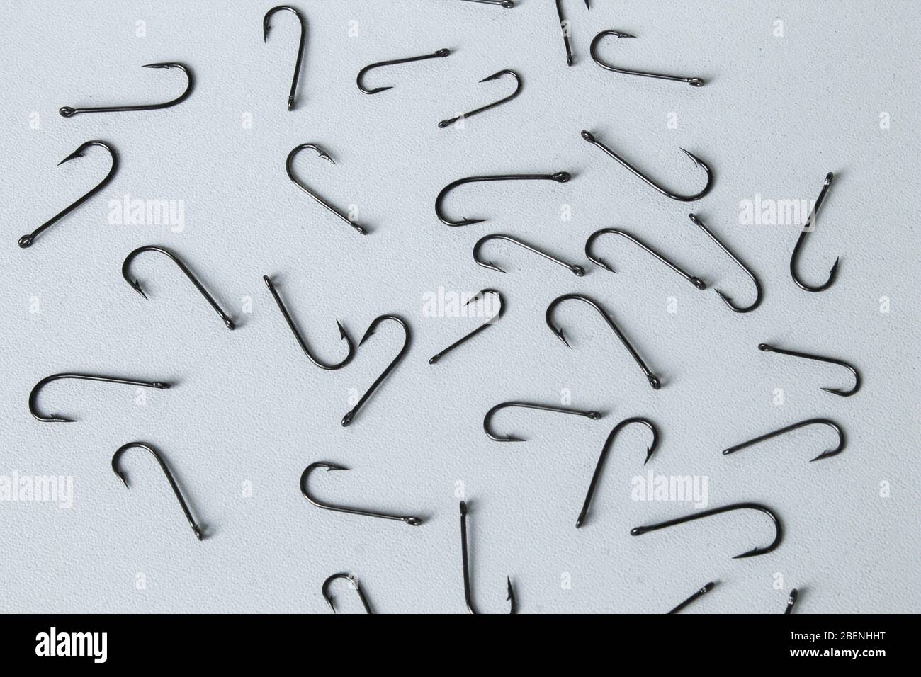 Fishing hooks on a white background Stock Photo - Alamy