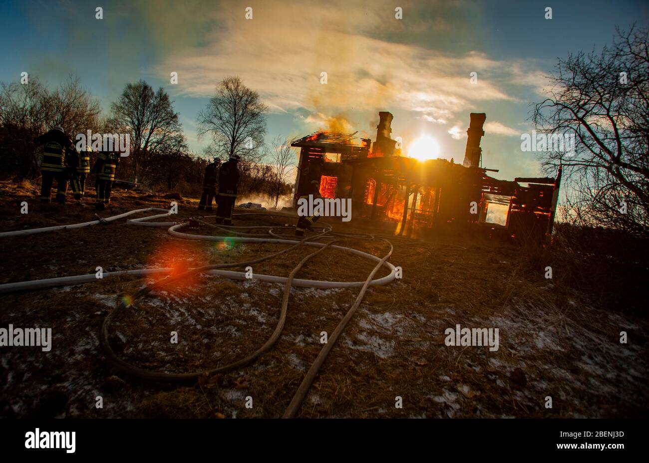 Firefighters trying to save burning house Stock Photo - Alamy