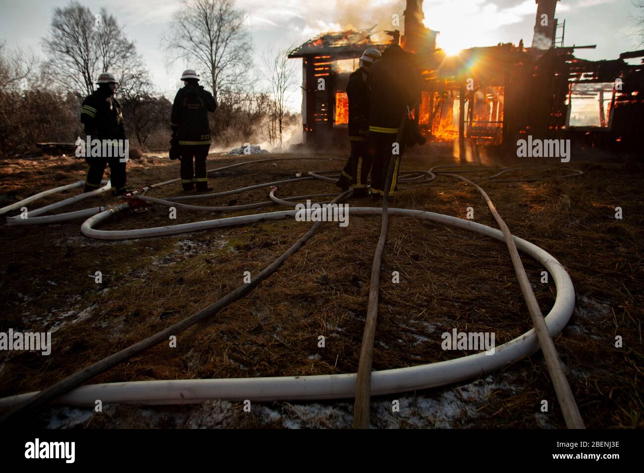 Firefighters trying to save burning house Stock Photo - Alamy
