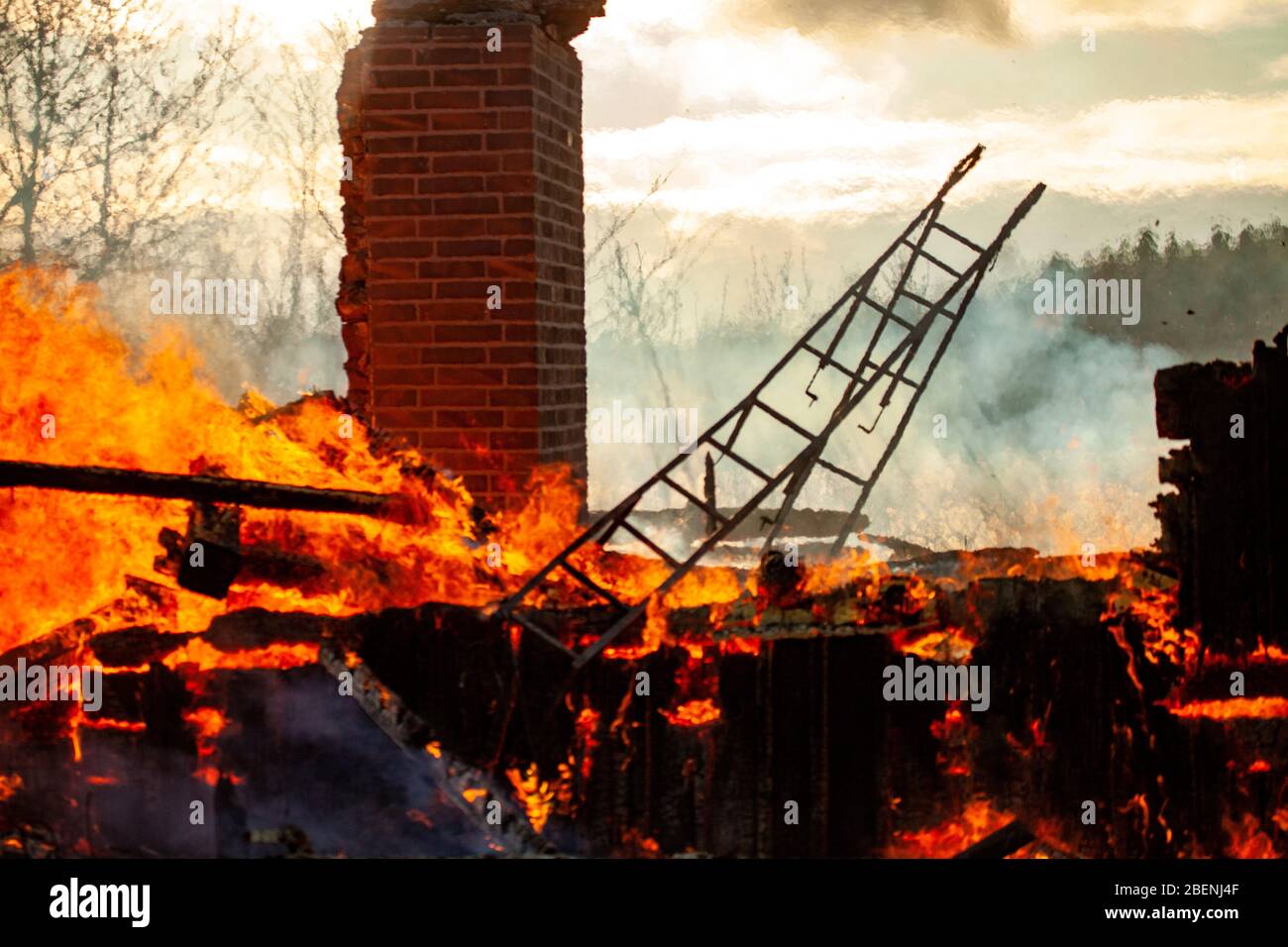 Firefighters trying to save burning house Stock Photo - Alamy