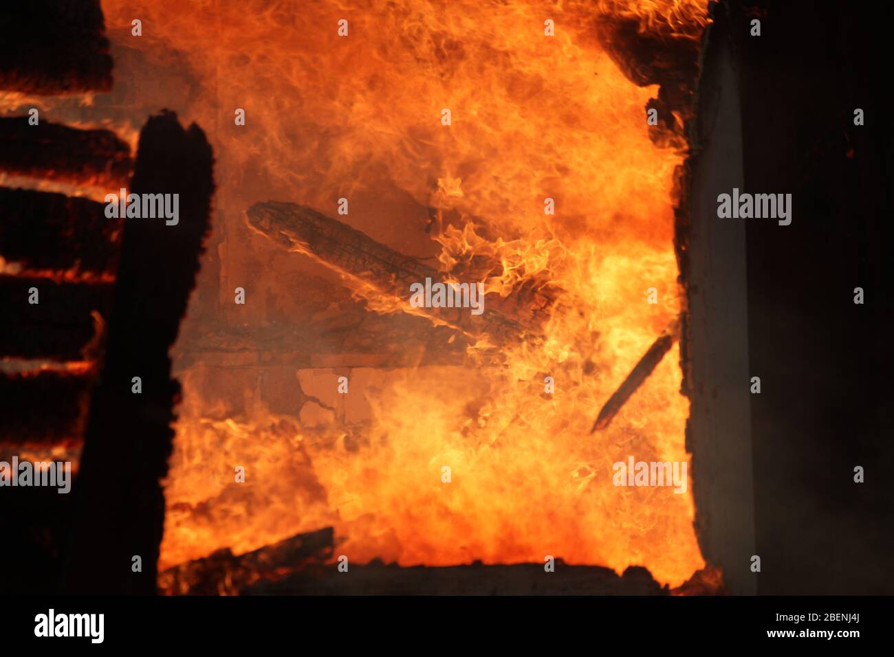 Firefighters trying to save burning house Stock Photo - Alamy
