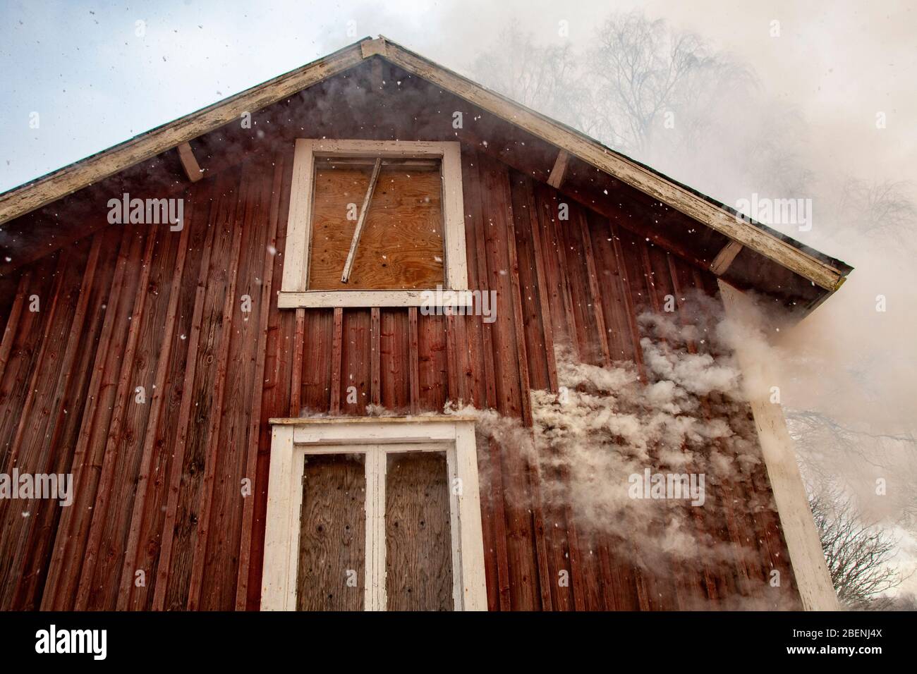 Firefighters trying to save burning house Stock Photo - Alamy