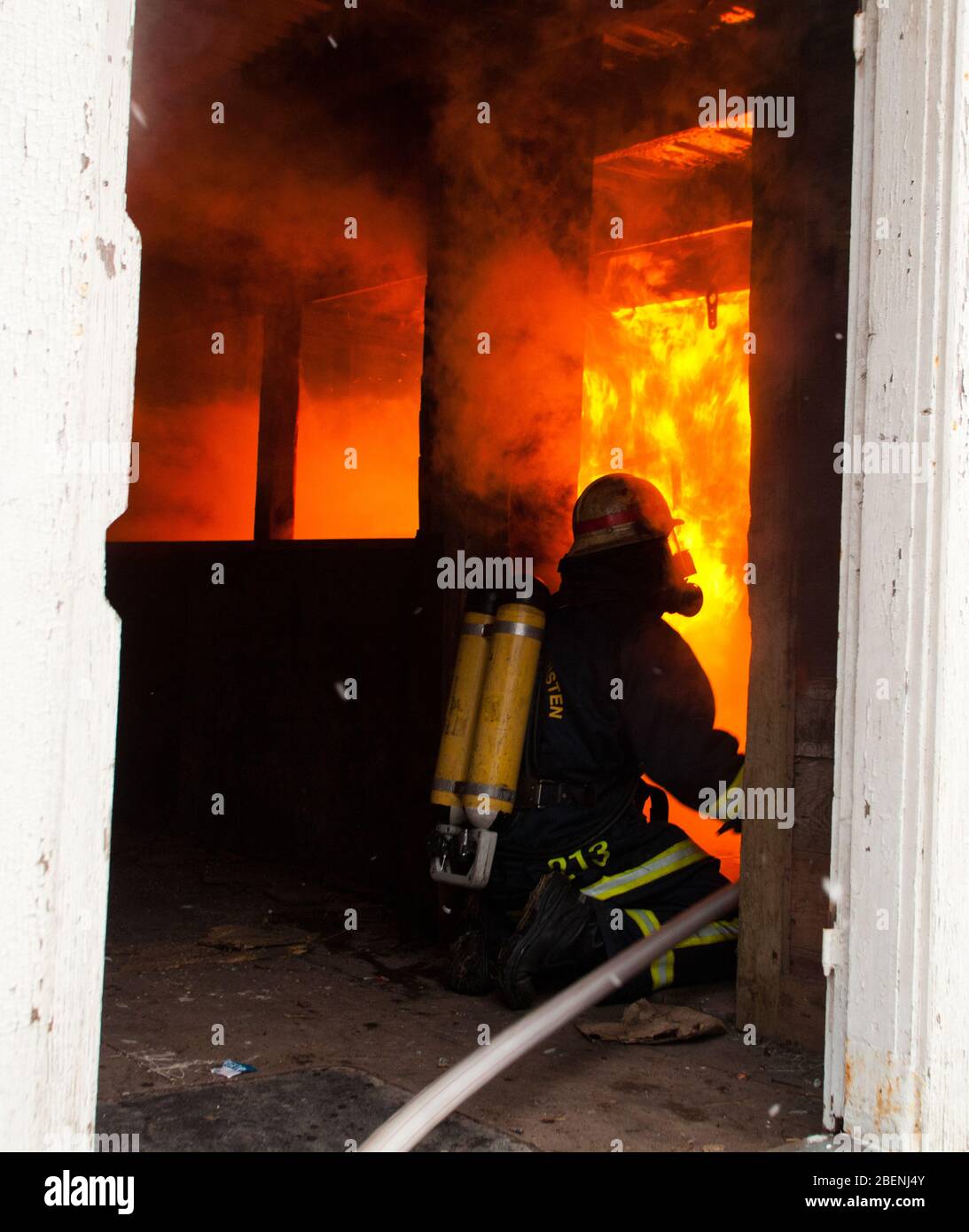 Firefighters trying to save burning house Stock Photo - Alamy