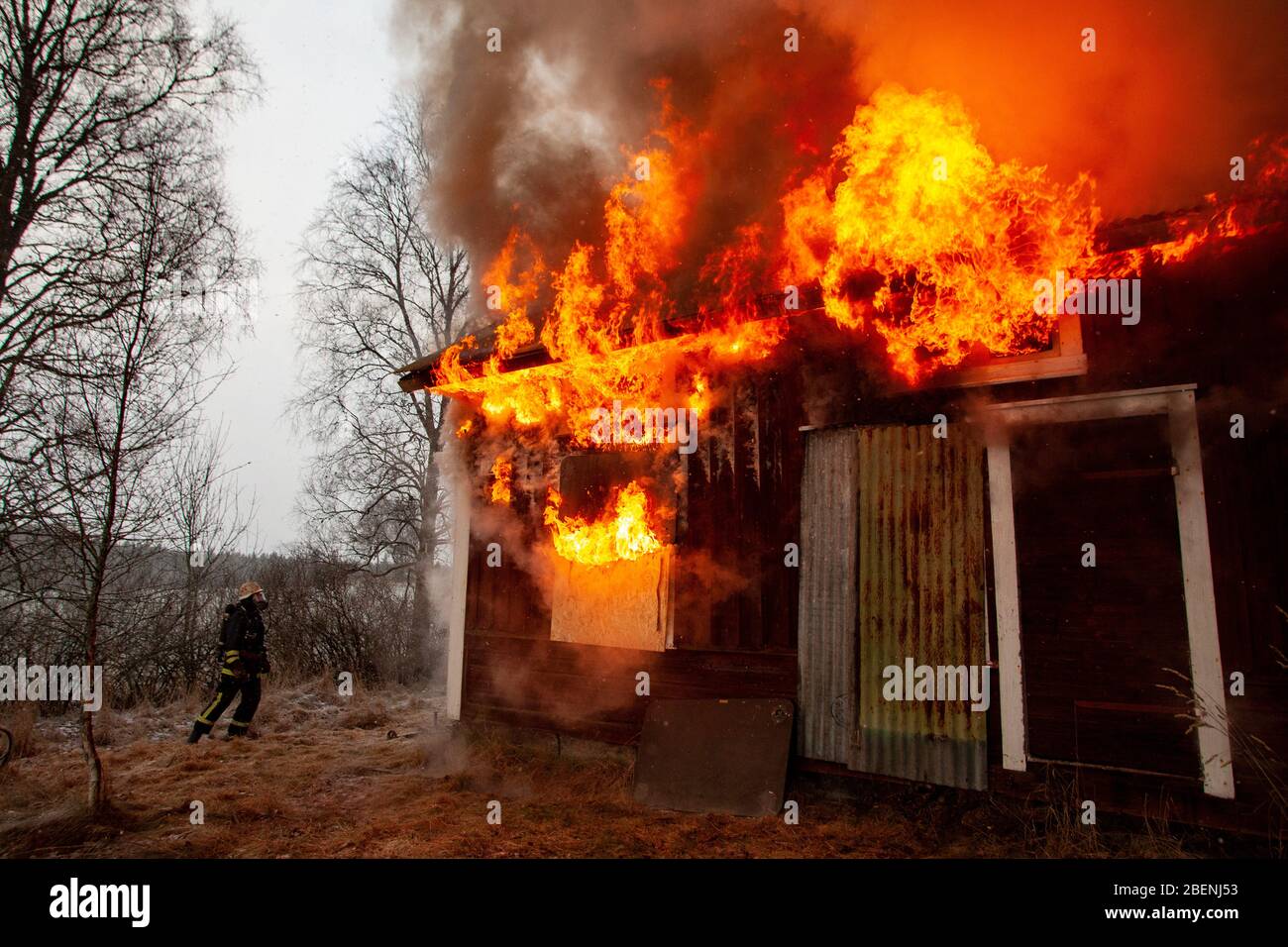 Firefighters trying to save burning house Stock Photo - Alamy