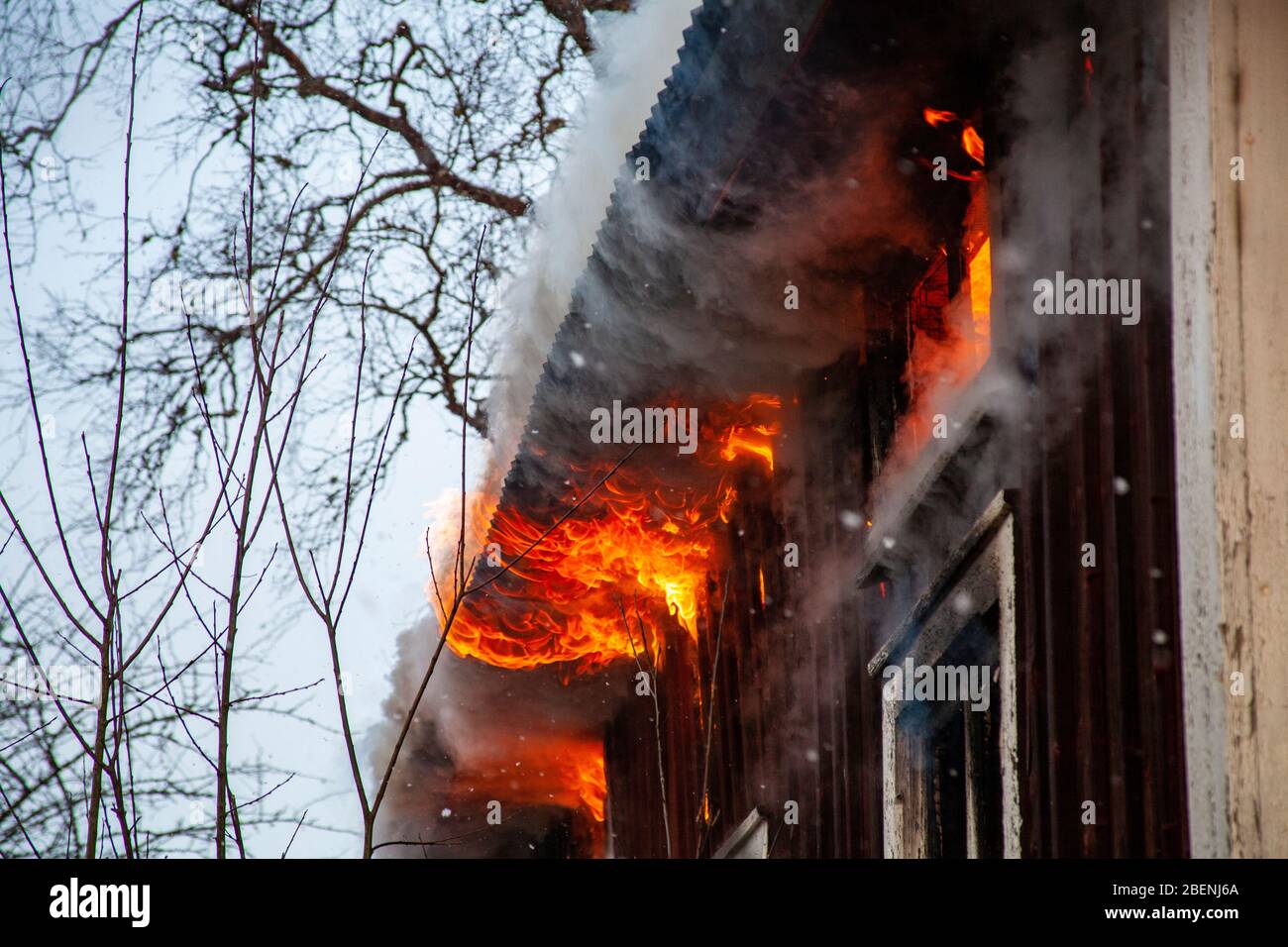 Firefighters trying to save burning house Stock Photo - Alamy