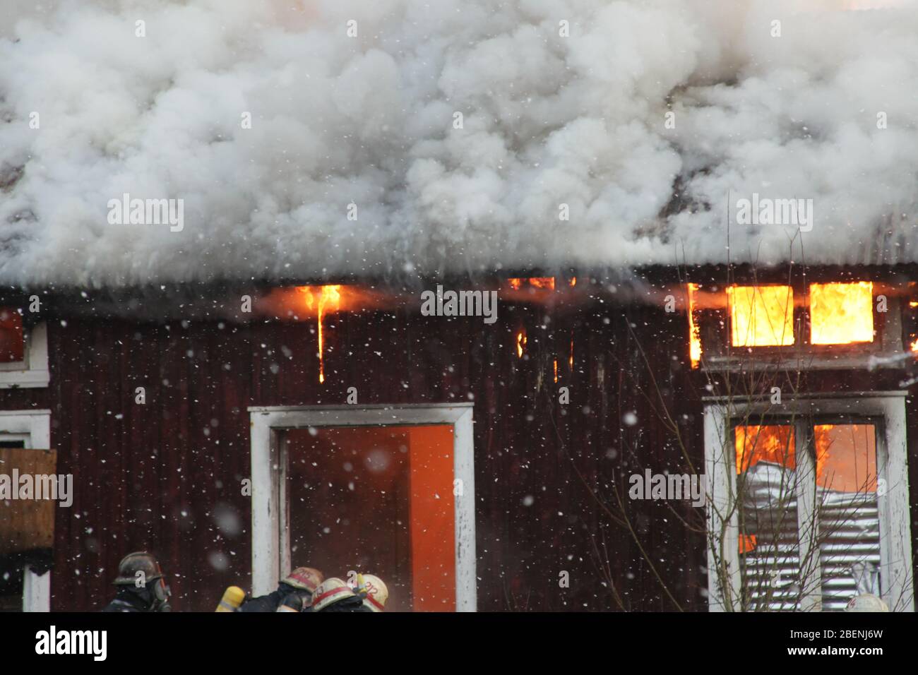 Firefighters trying to save burning house Stock Photo - Alamy