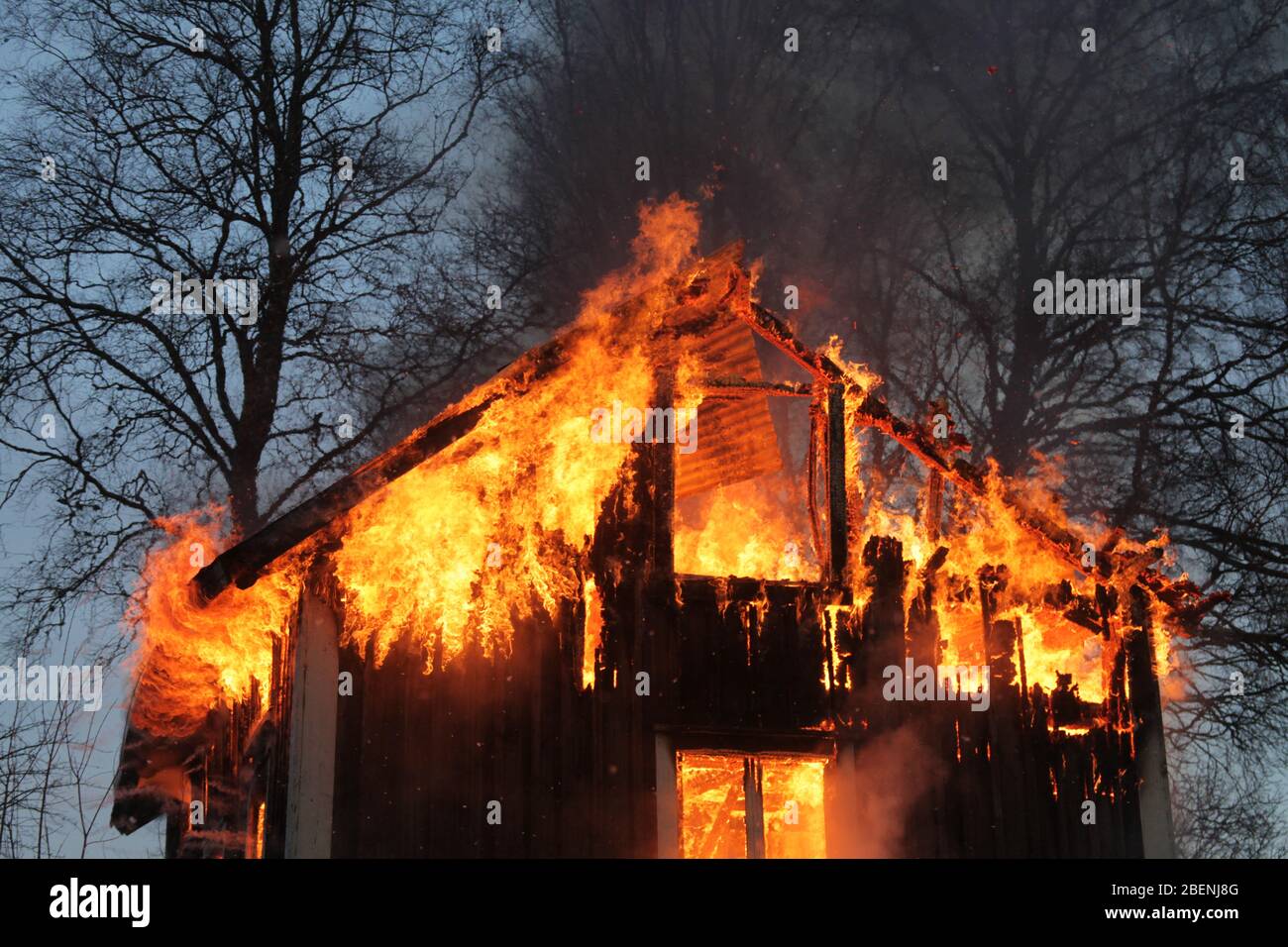 Firefighters trying to save burning house Stock Photo - Alamy