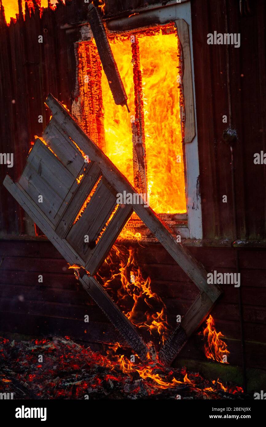 Firefighters trying to save burning house Stock Photo - Alamy