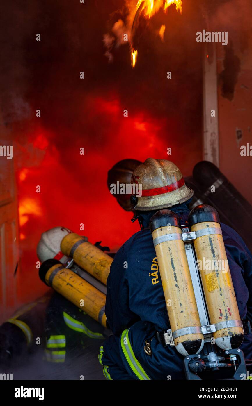 Firefighters trying to save burning house Stock Photo - Alamy