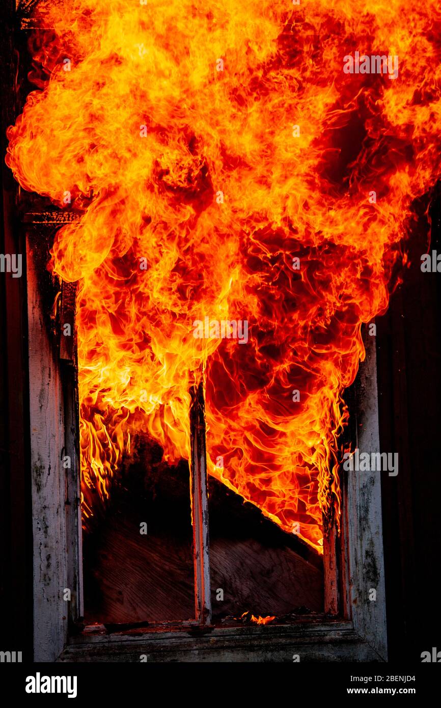 Firefighters trying to save burning house Stock Photo - Alamy