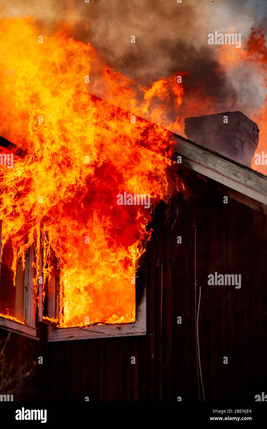 Firefighters trying to save burning house Stock Photo - Alamy