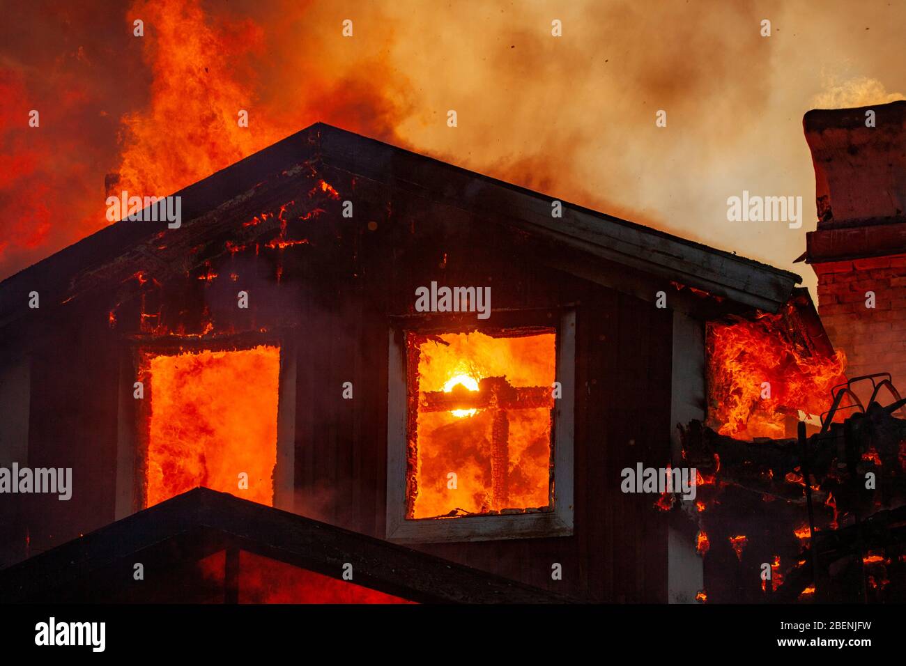 Firefighters trying to save burning house Stock Photo - Alamy