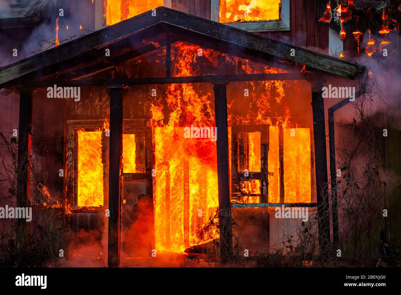 Firefighters trying to save burning house Stock Photo - Alamy