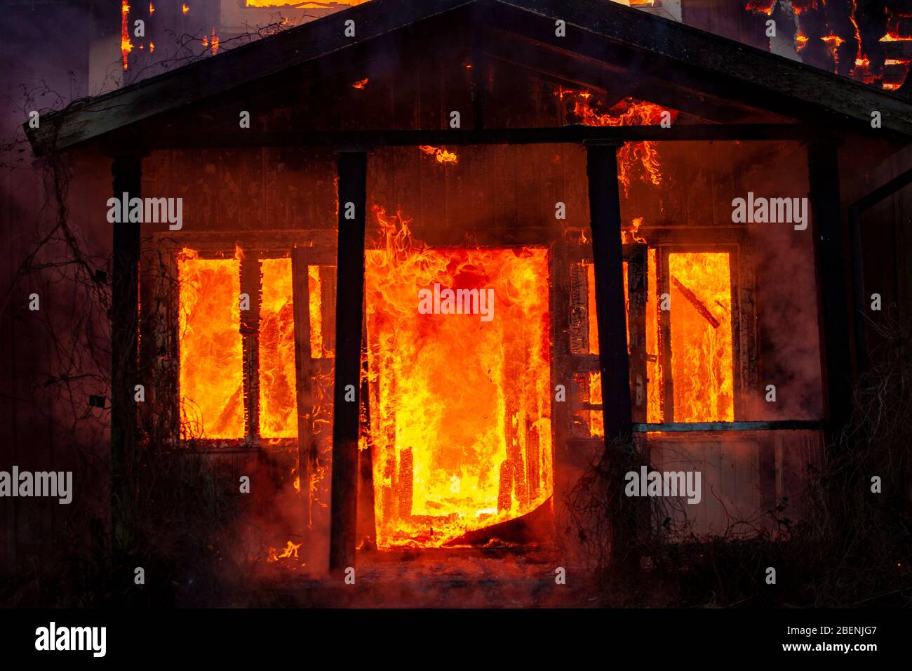 Firefighters trying to save burning house Stock Photo - Alamy