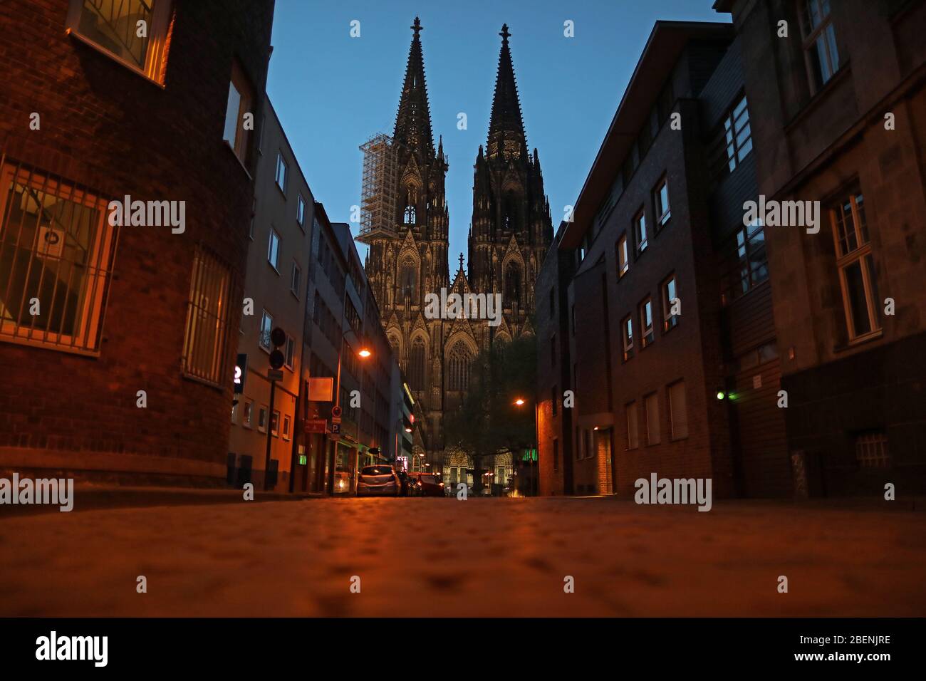 Cologne, Germany. 15th Apr, 2020. An alley by the cathedral is deserted ...