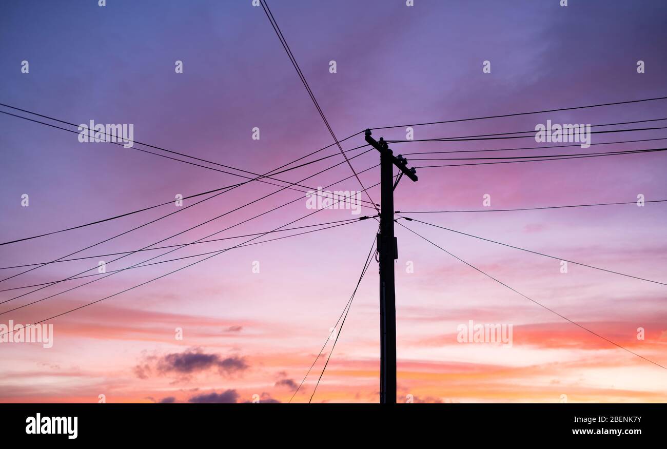 Electric pole and lines during sunset in rural Stock Photo - Alamy