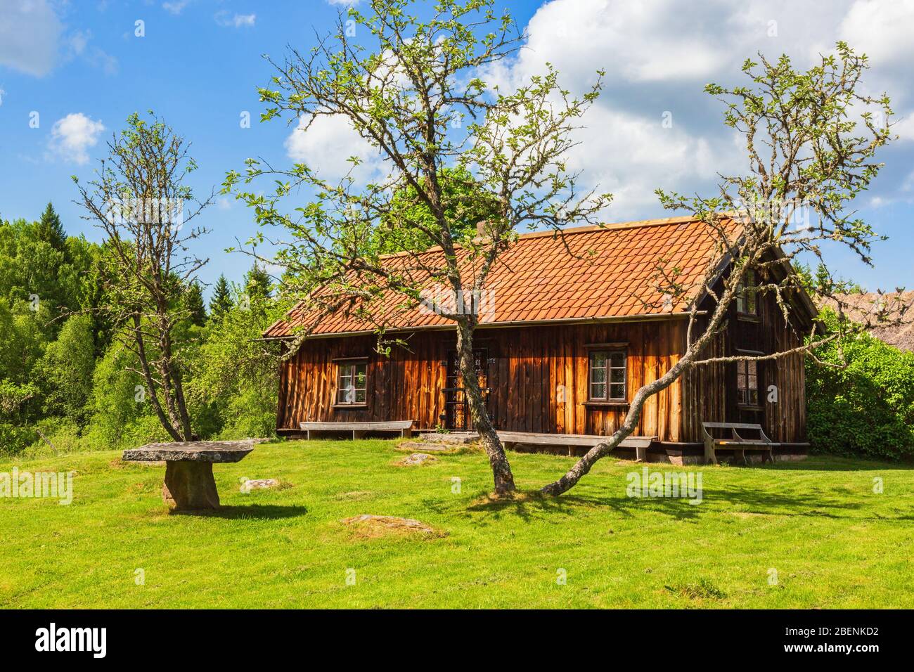 Old idyllic wooden cottage with trees in the garden Stock Photo - Alamy