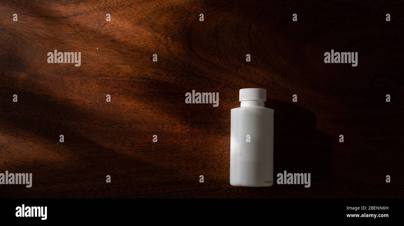 White bottle on a wooden background and shadow. Chemical Solvent Bottle ...