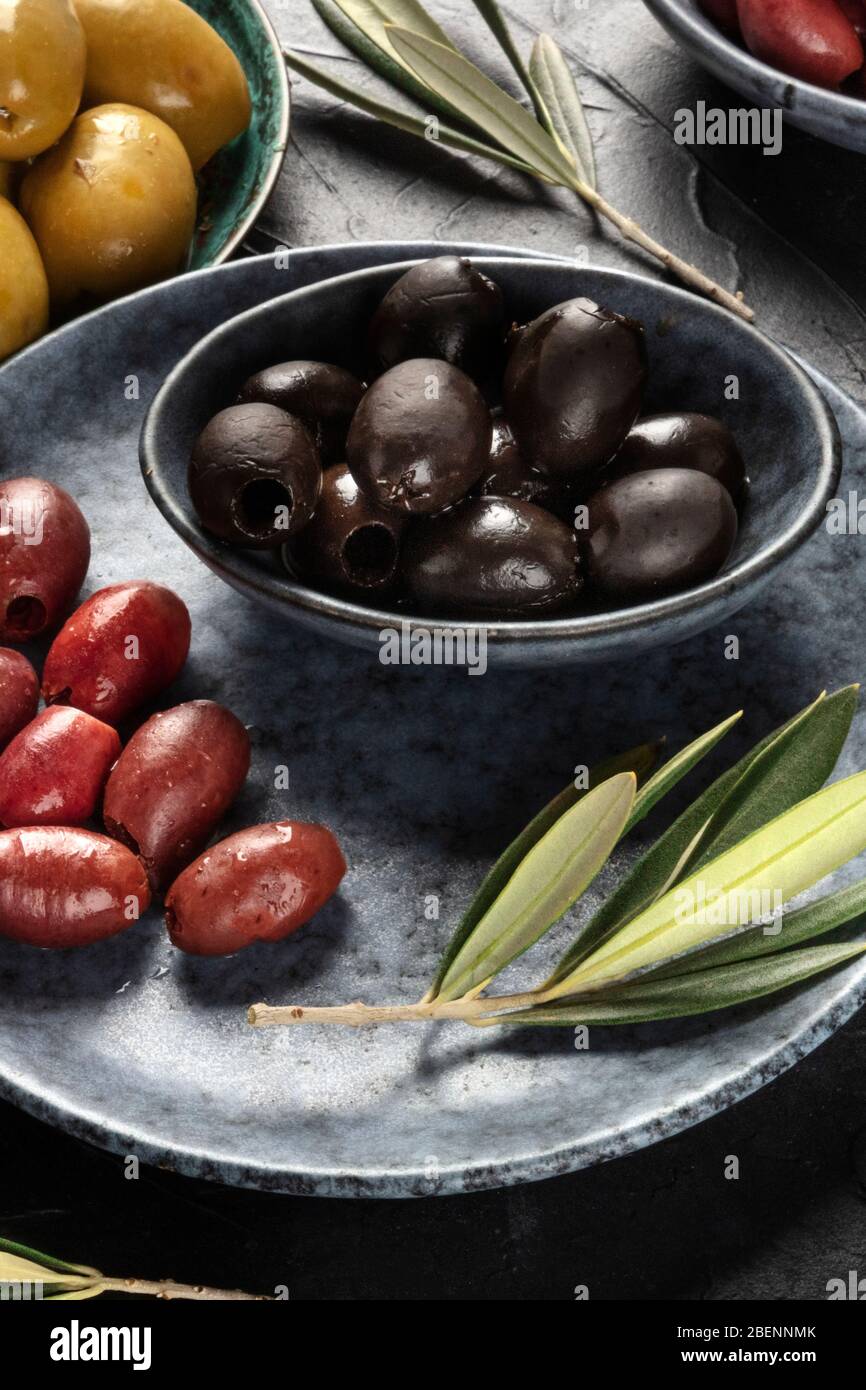 Olives, green, black and red, an assortment on a dark background Stock ...