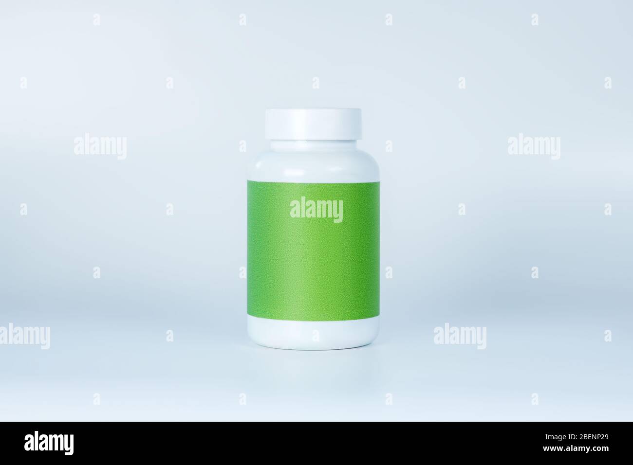 A bottle of supplements with green label Stock Photo - Alamy