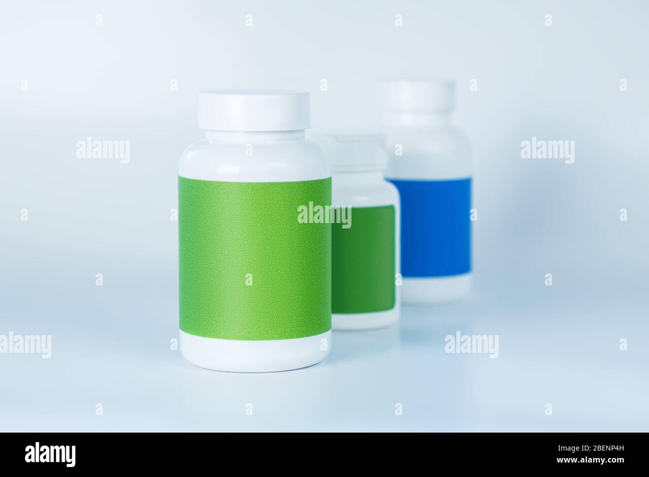 Three bottles of vitamins in one row next to each other Stock Photo - Alamy