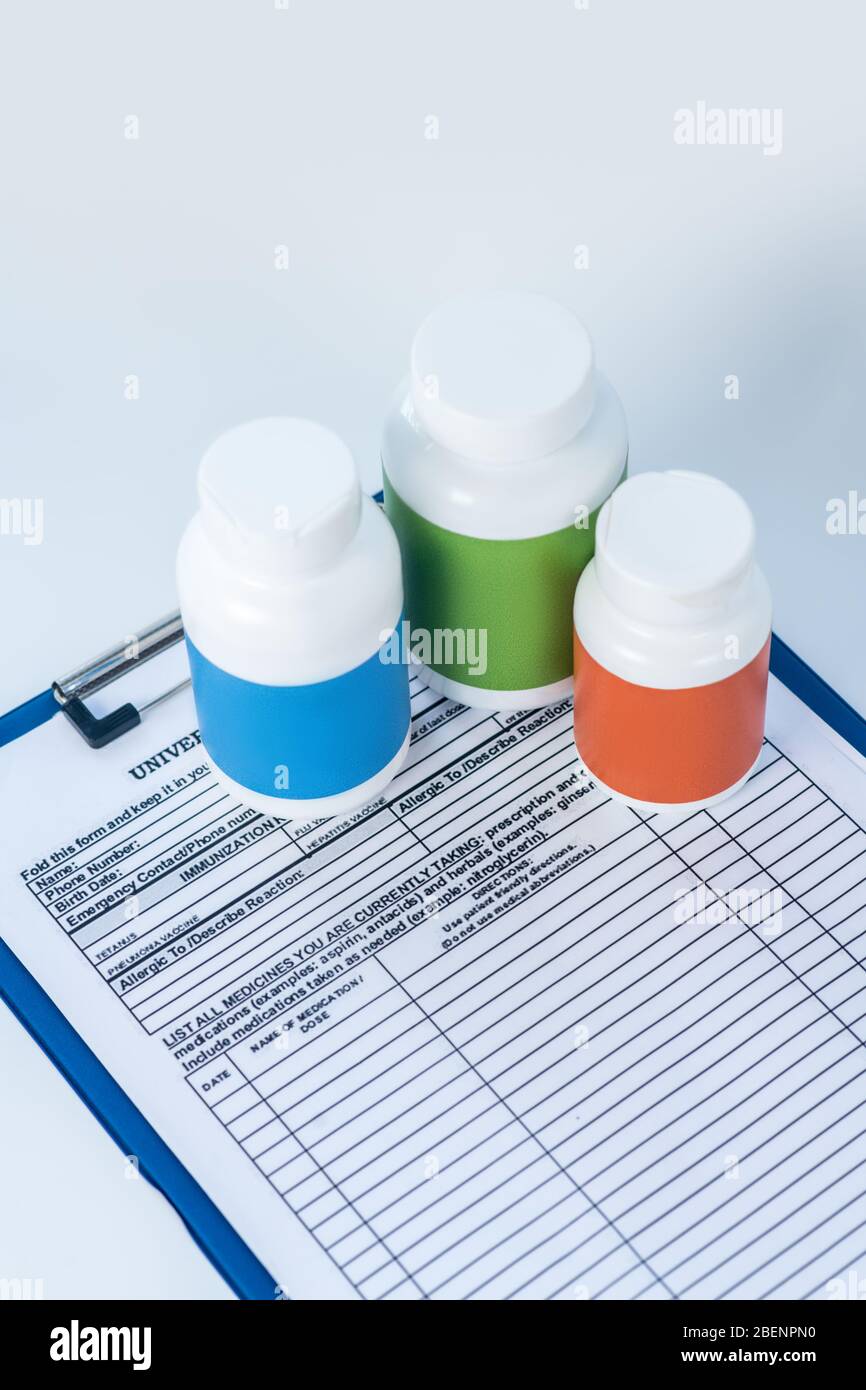Three bottles of pills on the table on a patient file Stock Photo - Alamy