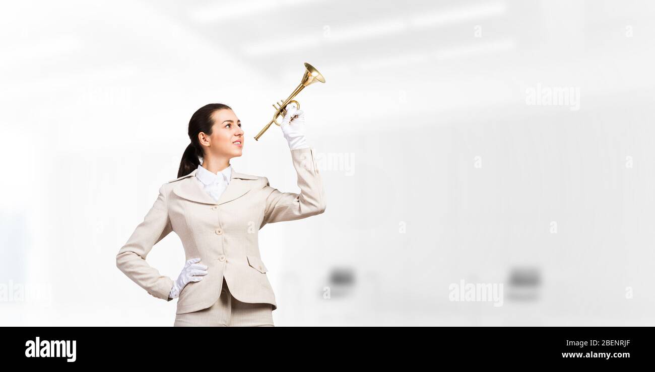 Beautiful woman playing trumpet brass Stock Photo - Alamy