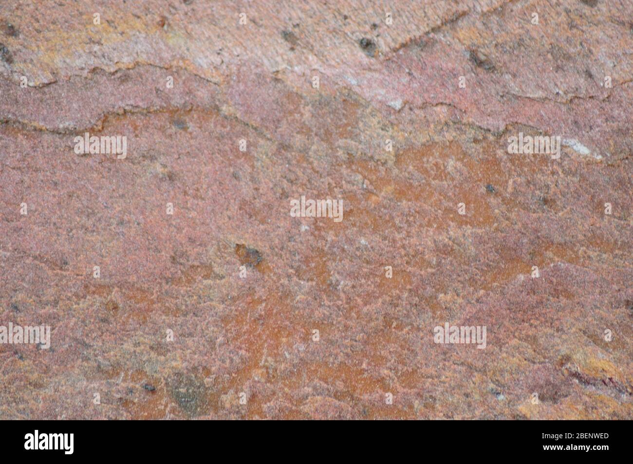 Roughly processed surface of brown sandstone close-up. Background ...