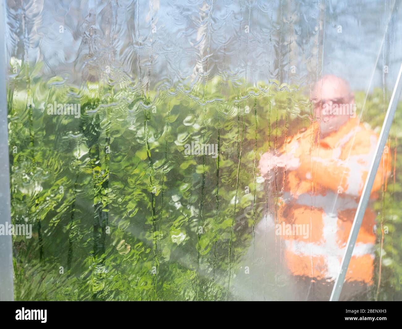 Construction worker cleaning filth with high pressure cleaner from a ...