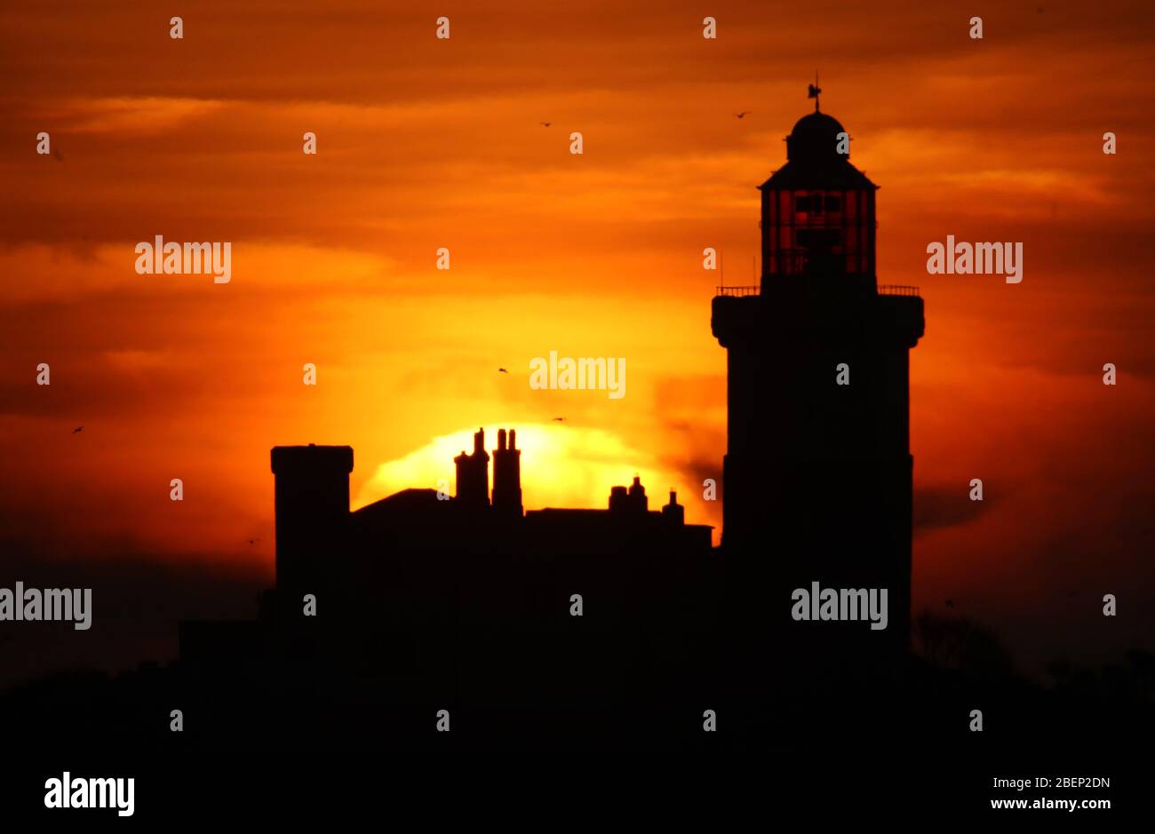 The sun rises behind coquet lighthouse on coquet island hi-res stock ...