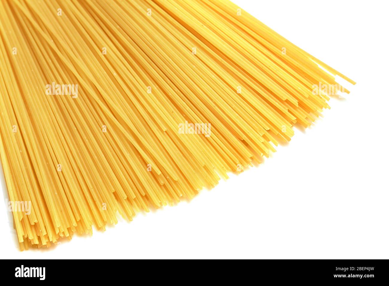 Raw spaghetti, yellow pasta isolated on white Stock Photo - Alamy