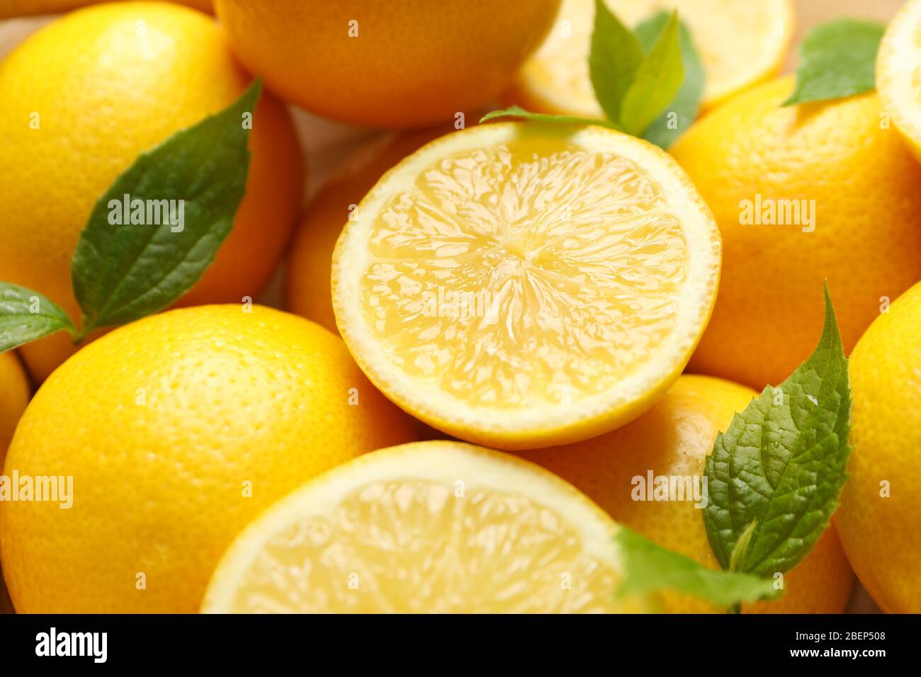 Lemons with leaves on whole background, close up. Ripe fruit Stock ...