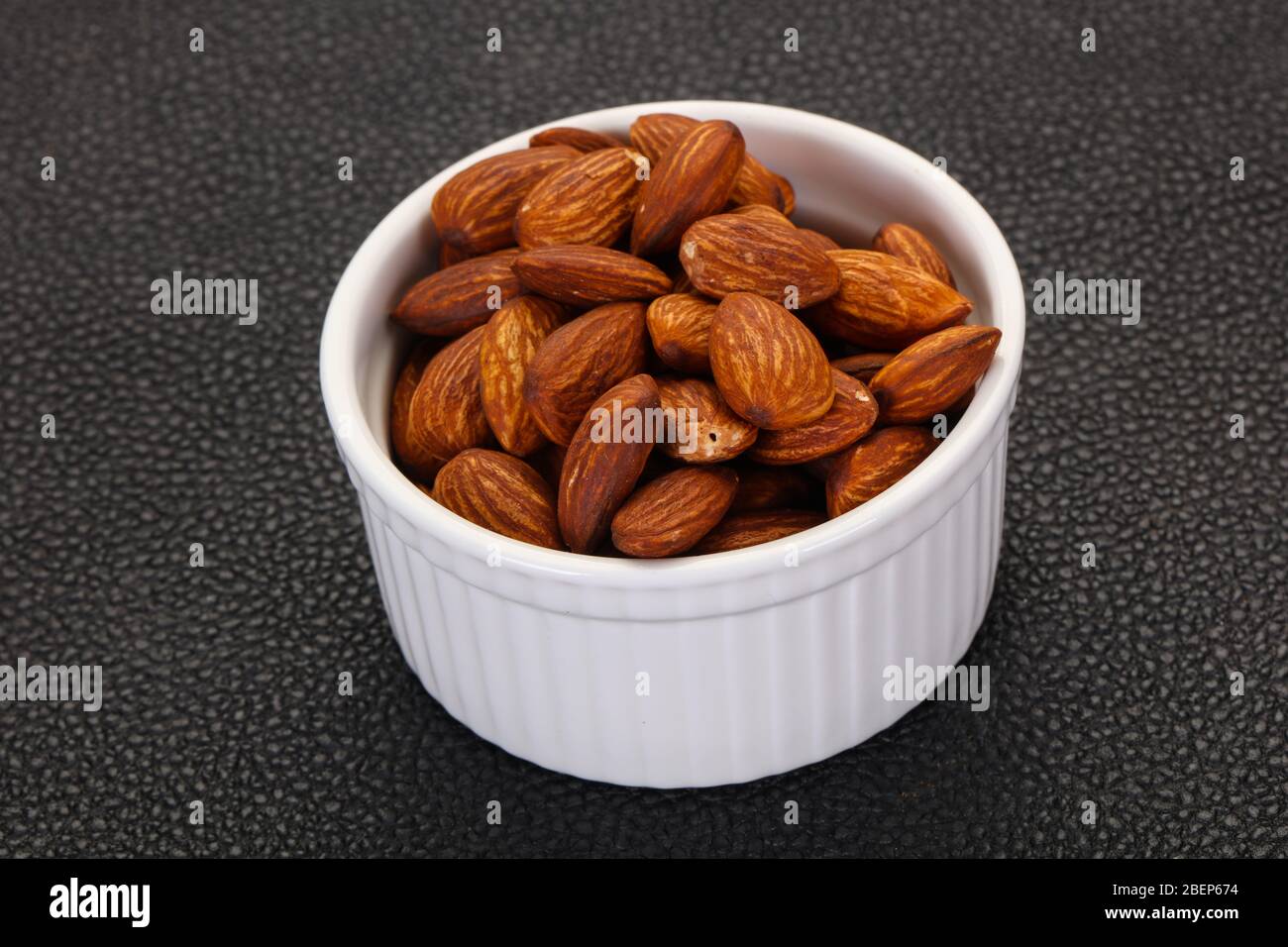 Almonds nuts heap in the bowl Stock Photo - Alamy