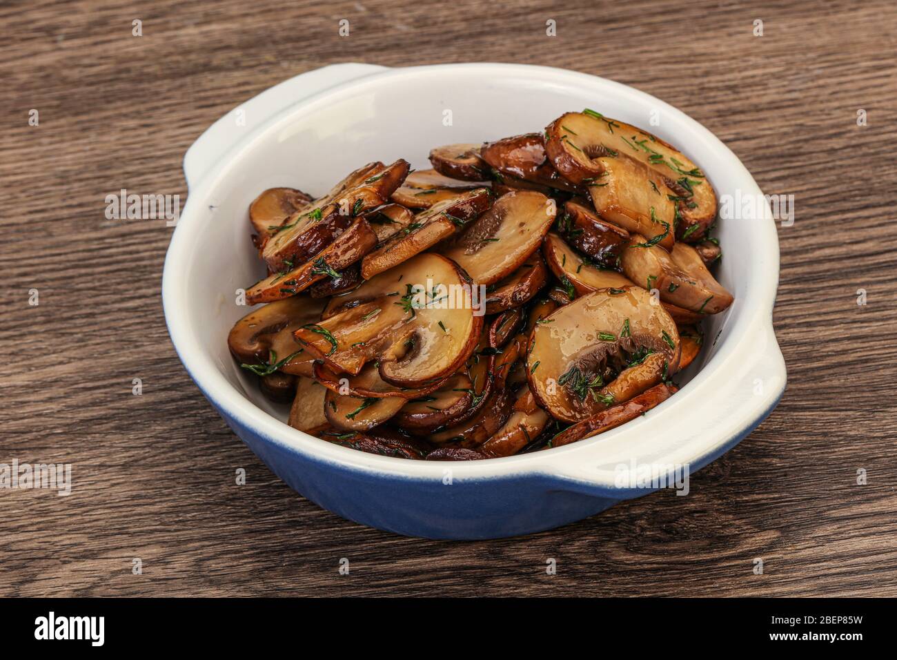 Roasted champignon with herbs and spices in the bowl Stock Photo - Alamy