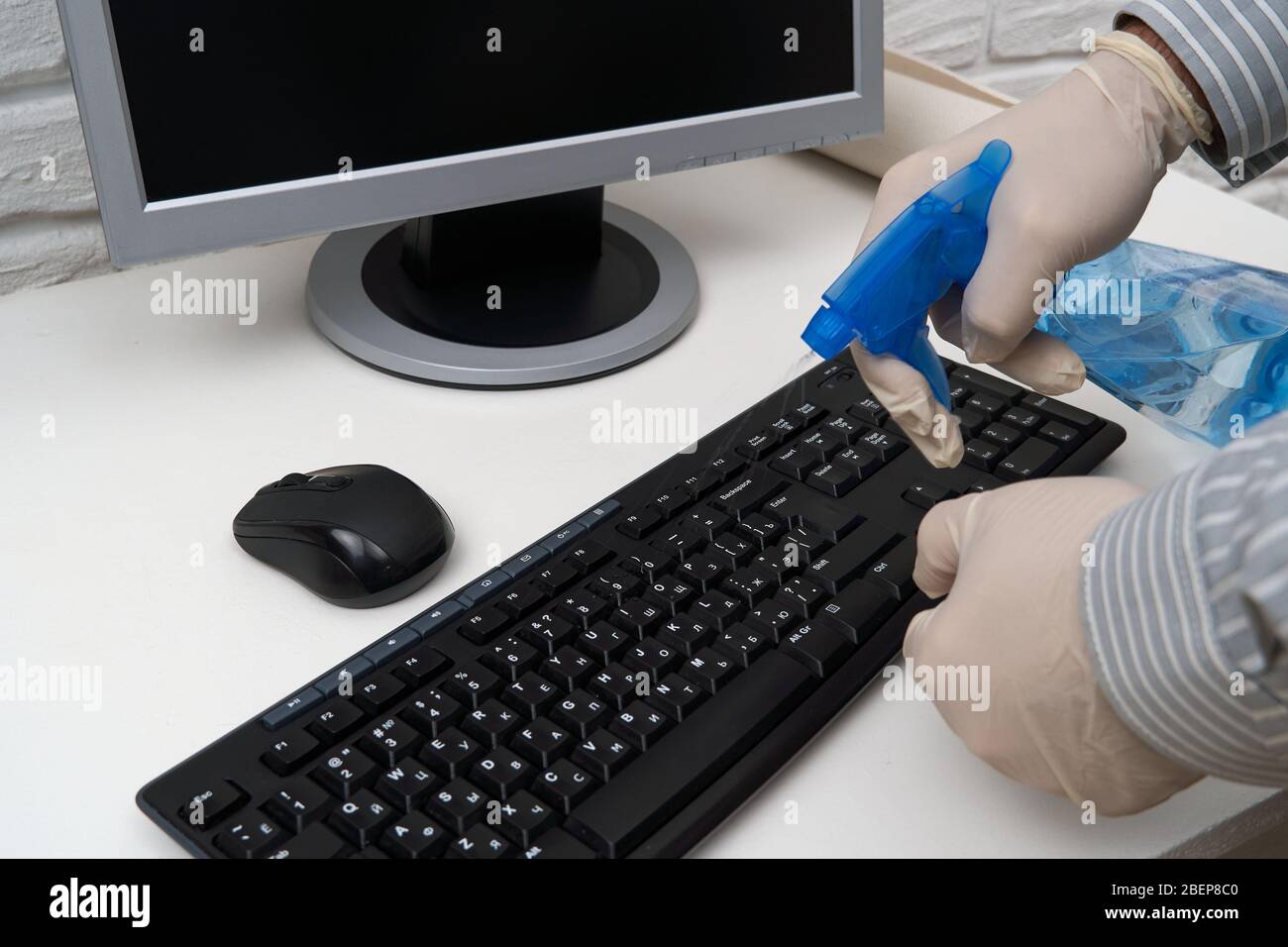concept of cleaning or disinfecting the office - a businessman cleans ...