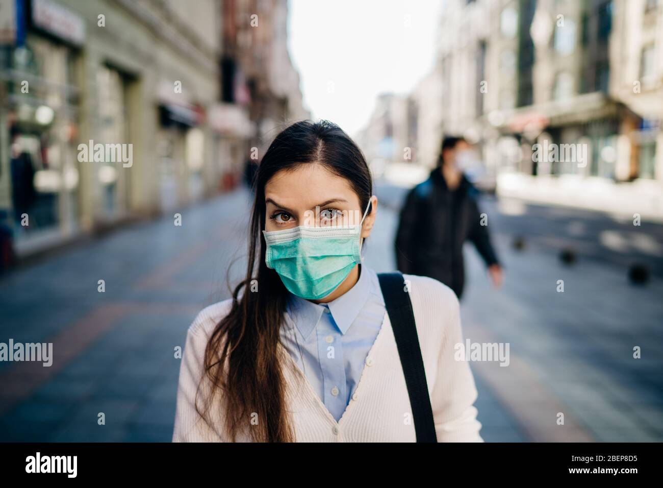 Suspicious young adult walking in public space during pandemic.Effect ...